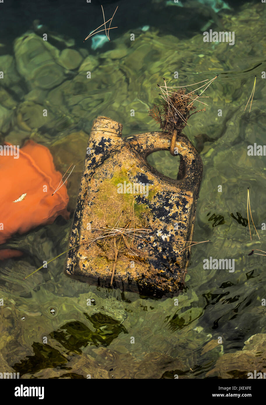 Plastic oil container floating on water Stock Photo - Alamy