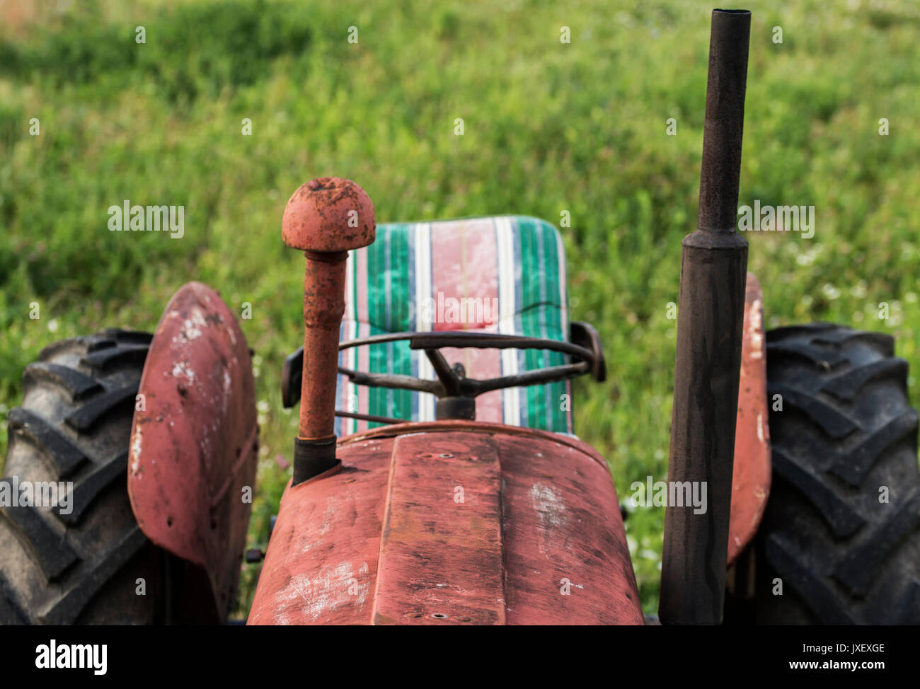 Red old tractor front part with seat Stock Photo - Alamy