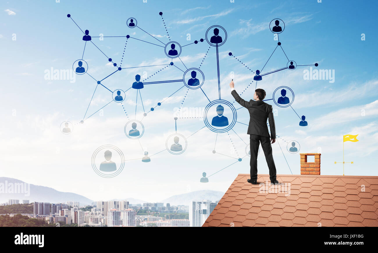Businessman on house roof presenting networking and connection concept ...