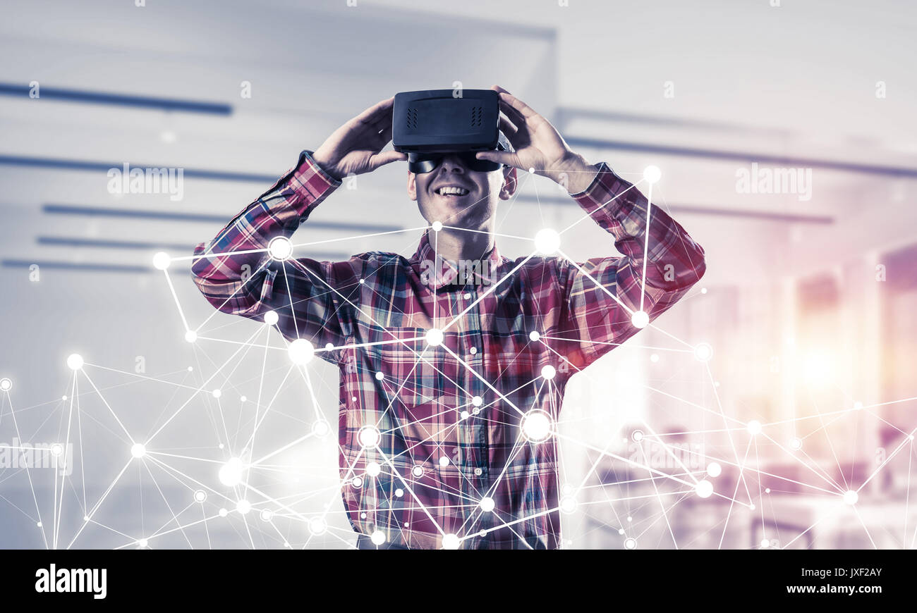 Guy wearing checked shirt and virtual mask demonstrating some em Stock ...