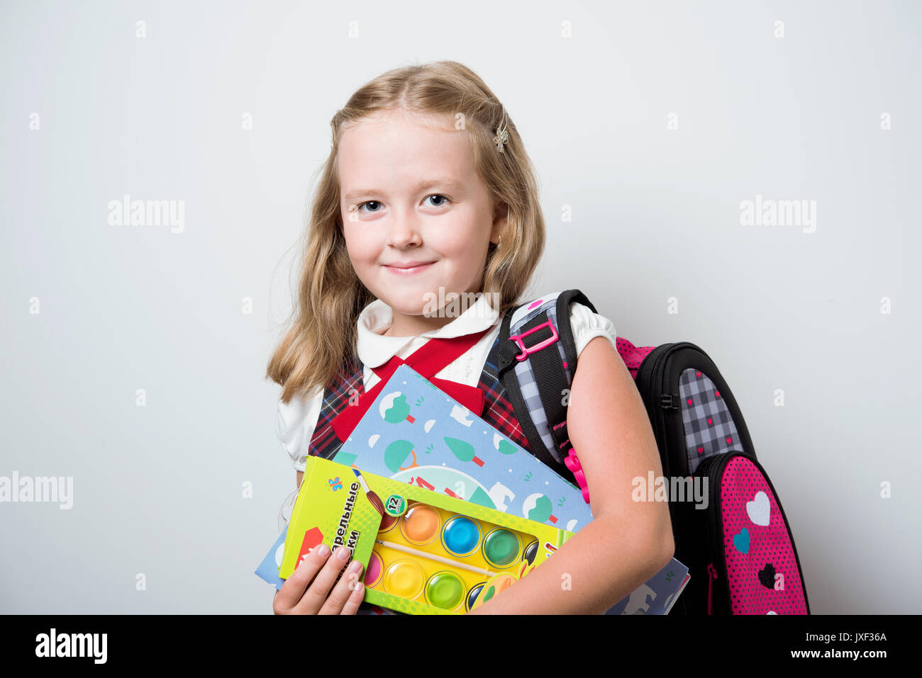 child in a school uniform with a backpack Stock Photo - Alamy
