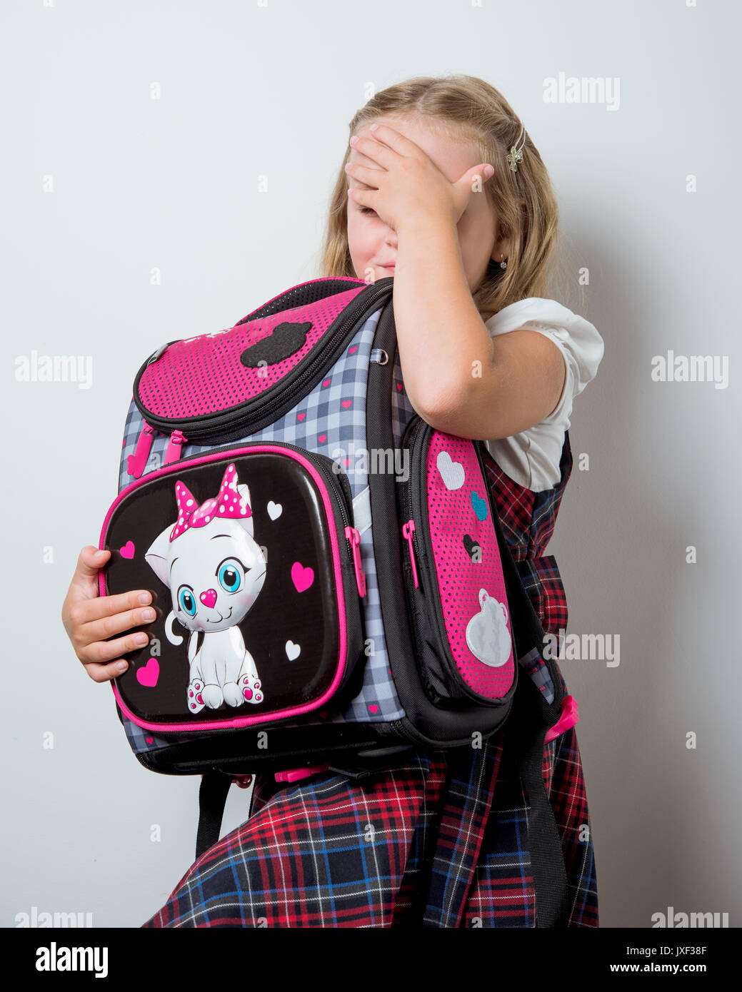 child in a school uniform with a backpack Stock Photo - Alamy
