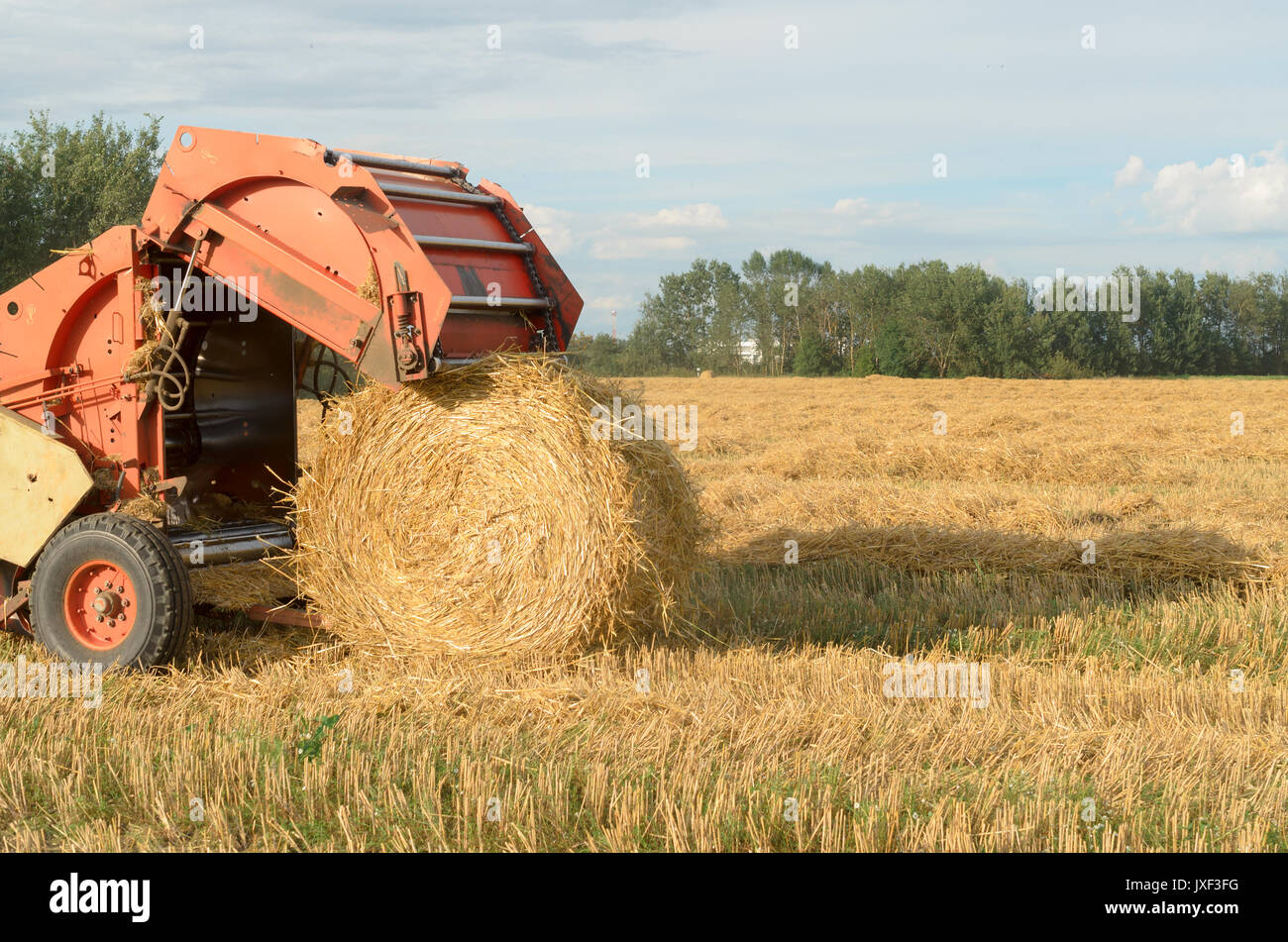 Special machines for harvesting form round bales of hay Stock Photo - Alamy