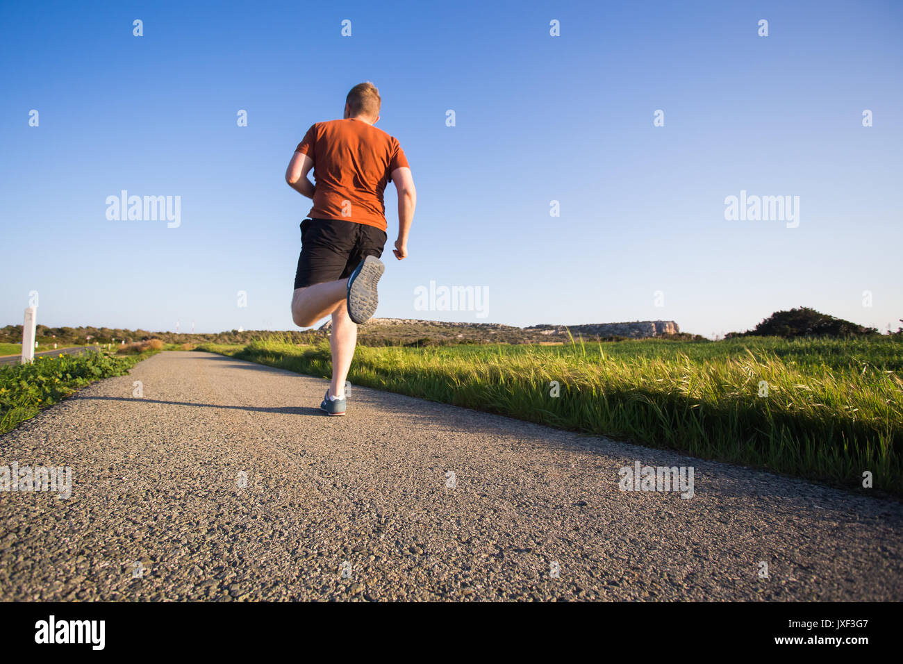 Athletic young man running in the nature. Healthy lifestyle Stock Photo ...