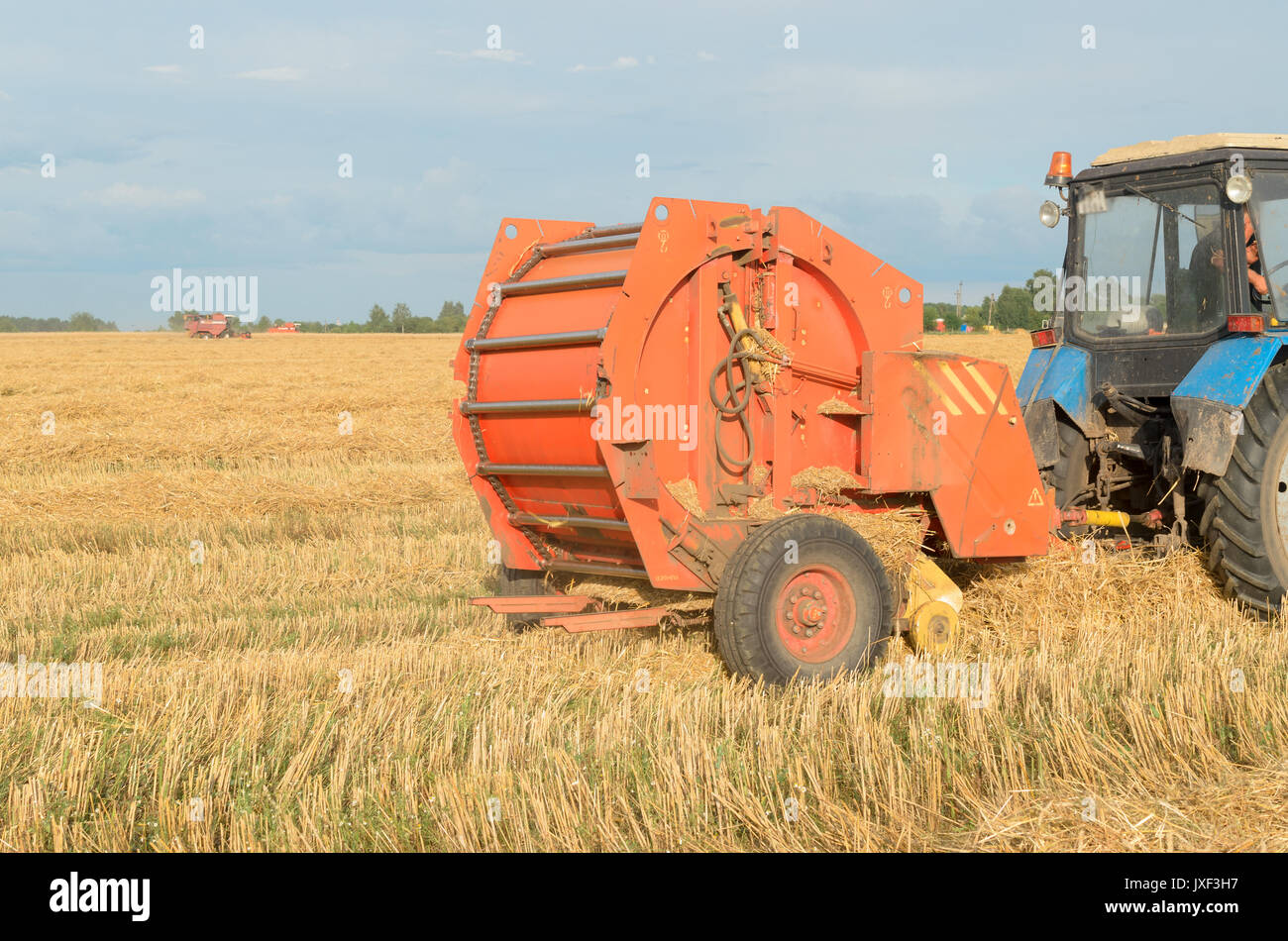 Special machines for harvesting form round bales of hay Stock Photo - Alamy