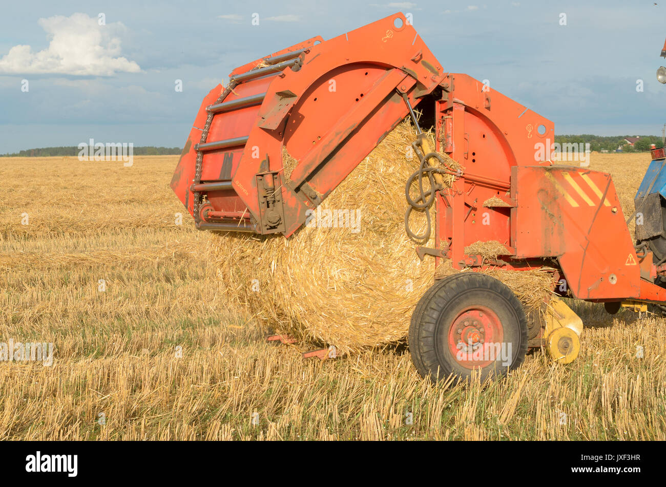 Special machines for harvesting form round bales of hay Stock Photo - Alamy