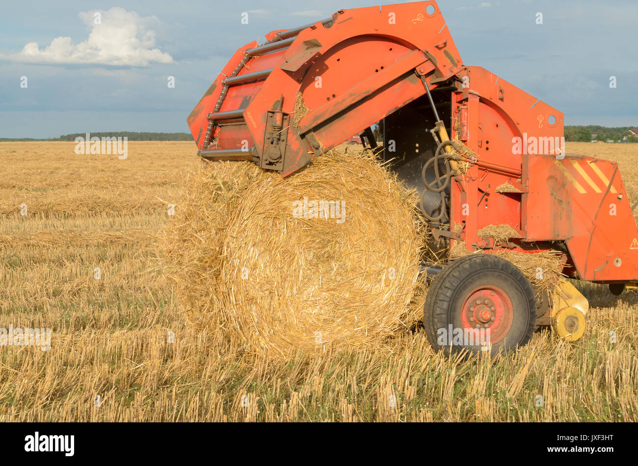 Special machines for harvesting form round bales of hay Stock Photo - Alamy