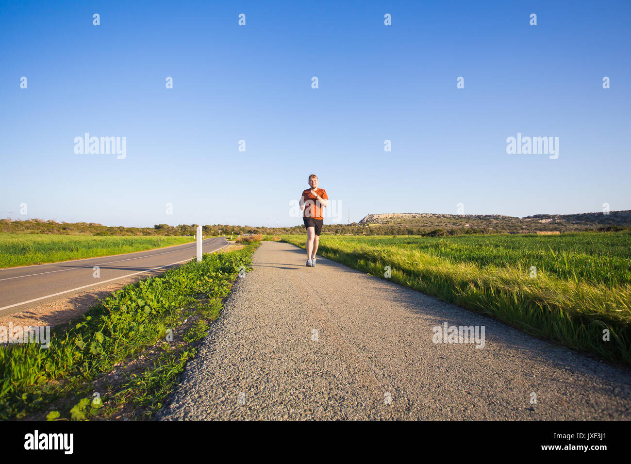 Athletic young man running in the nature. Healthy lifestyle Stock Photo ...