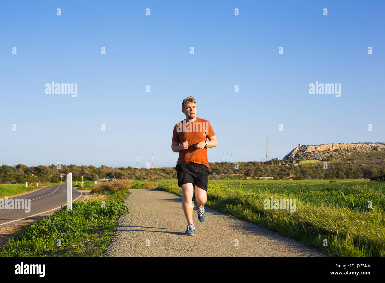 Athletic young man running in the nature. Healthy lifestyle Stock Photo ...