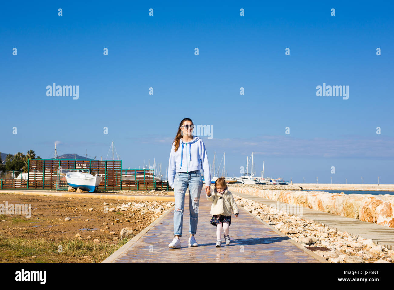 mother and daughter walking holding their hands Stock Photo - Alamy
