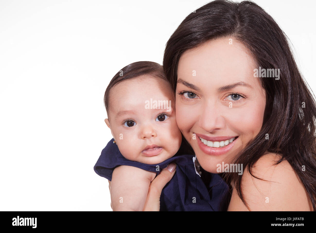 Mother and her baby girl looking at the camera Stock Photo - Alamy