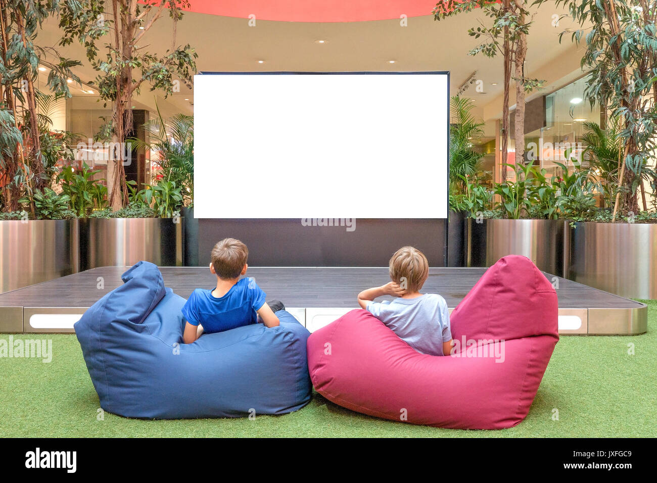 Mock up. Blank advertising screen in modern shopping mall. Children ...