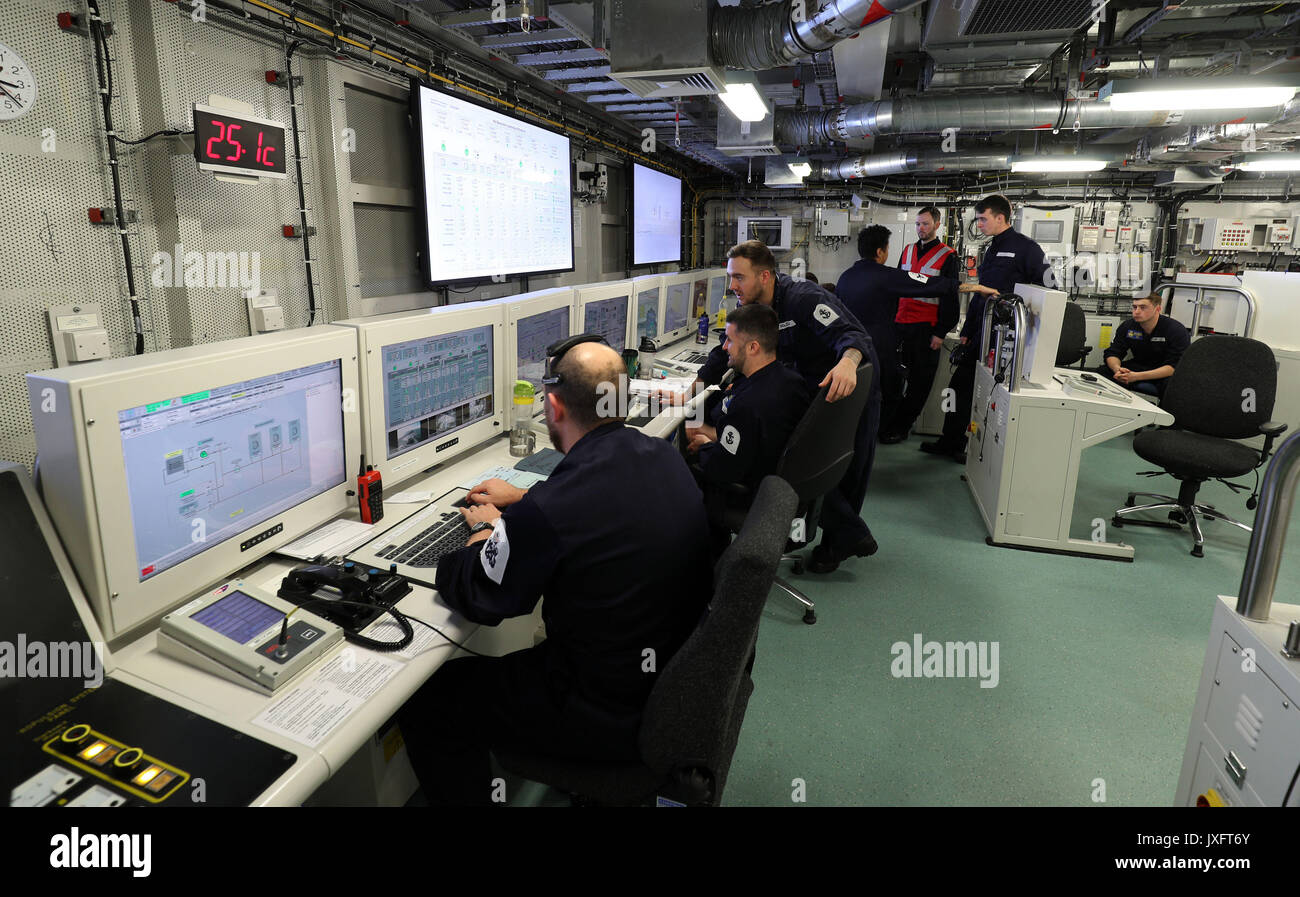 Crew members work in the ship control centre on board HMS Queen ...
