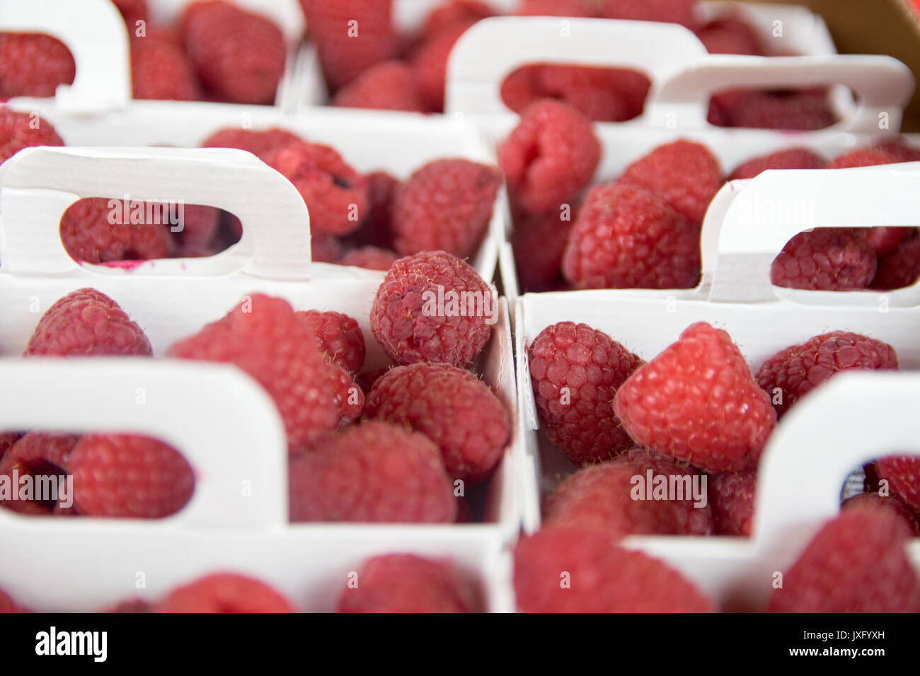 Raspberries boxes for sale Stock Photo - Alamy