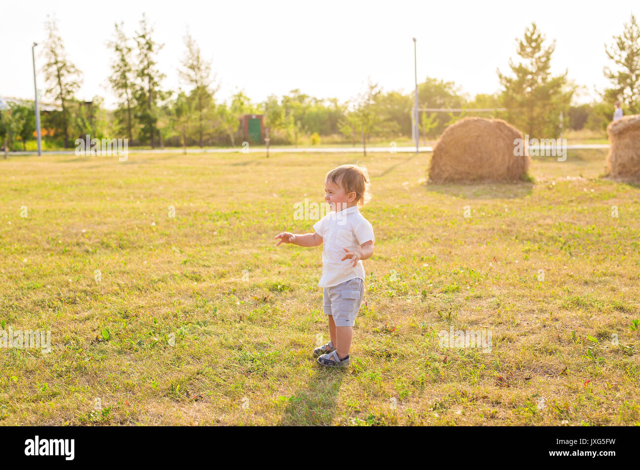 Portrait of cute little baby boy having fun outside. Smiling happy ...