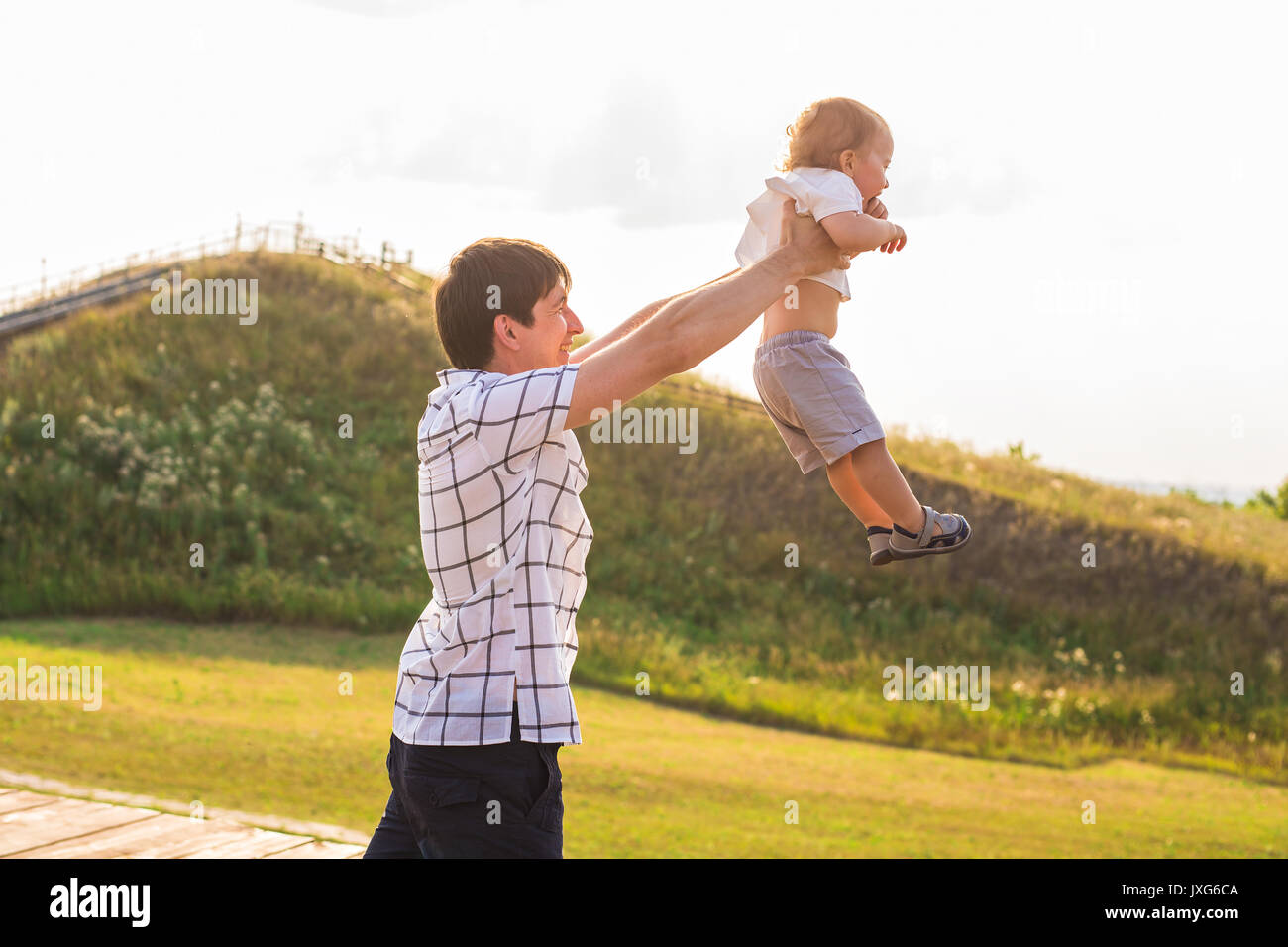 Happy young father and son playing together and having fun in the ...