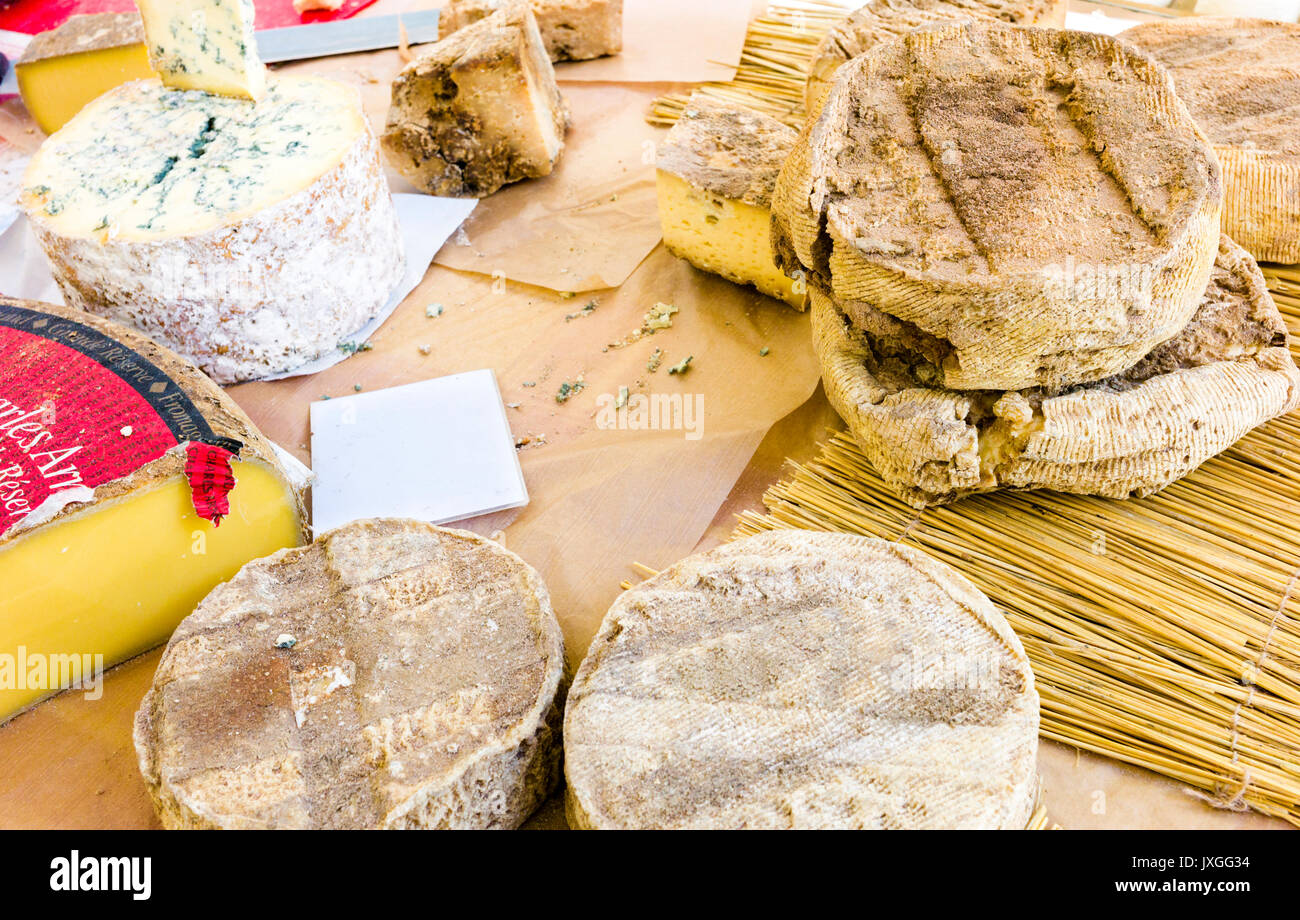 Rustic table of French cheeses at a market in Paris, France Stock Photo ...