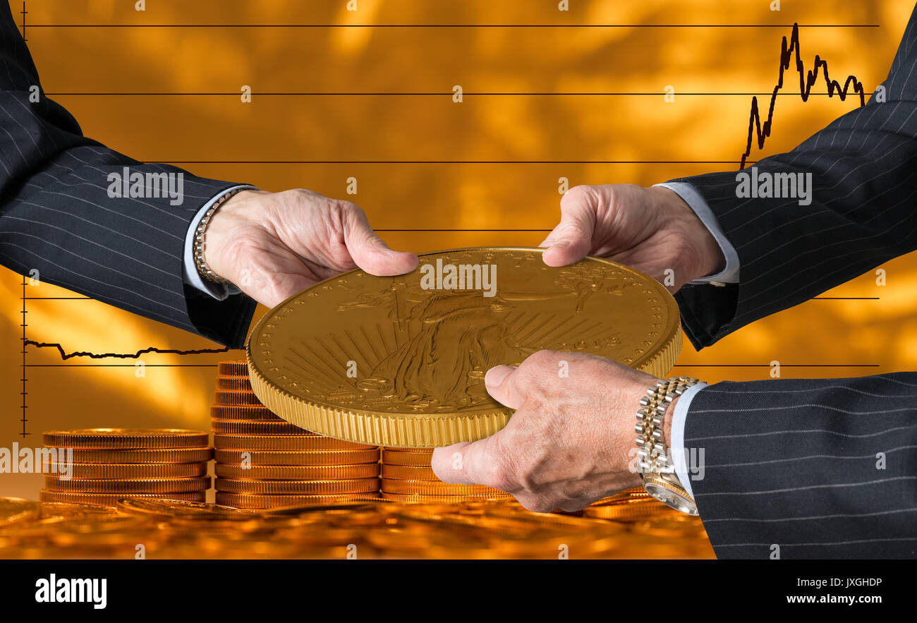 Three traders hands holding large gold coin Stock Photo - Alamy