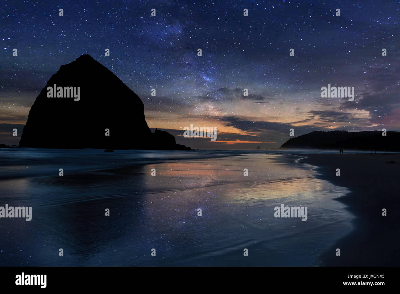 Haystack Rock at Cannon Beach under starry night sky in Oregon Coast ...