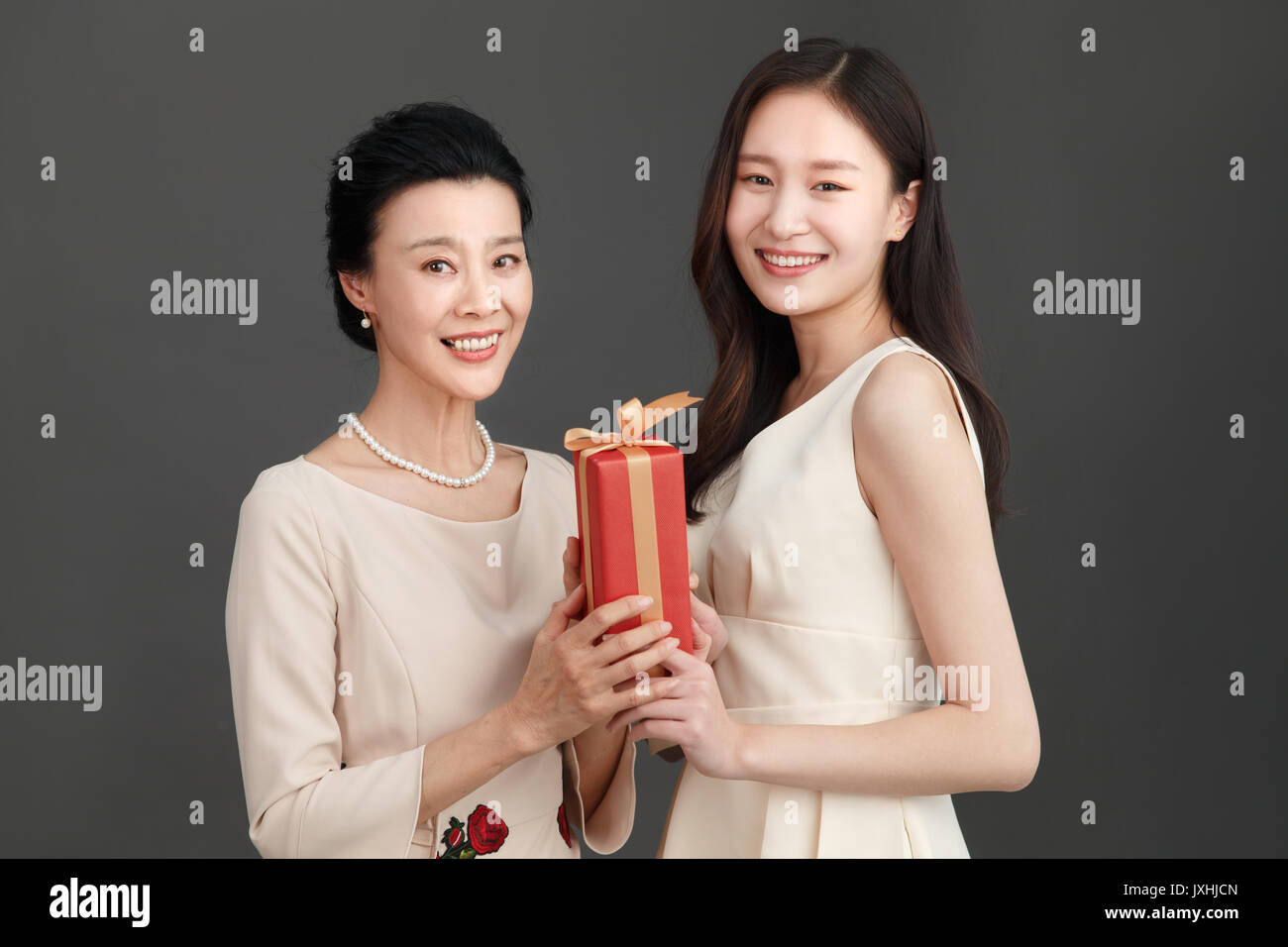 Daughter gave her mother a gift Stock Photo - Alamy