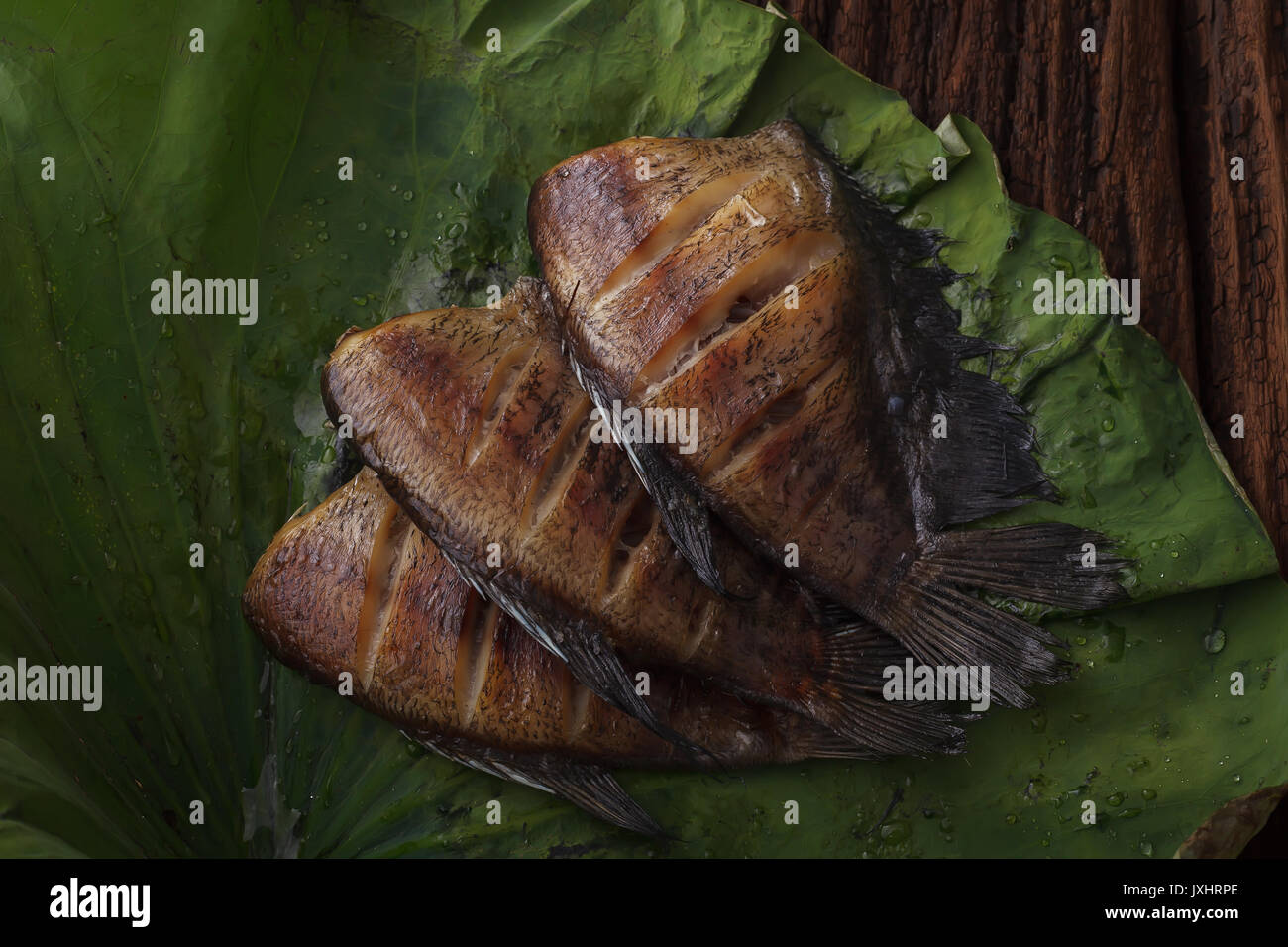 thai food dried salted damsel fish fried with leave lotus decoration on ...