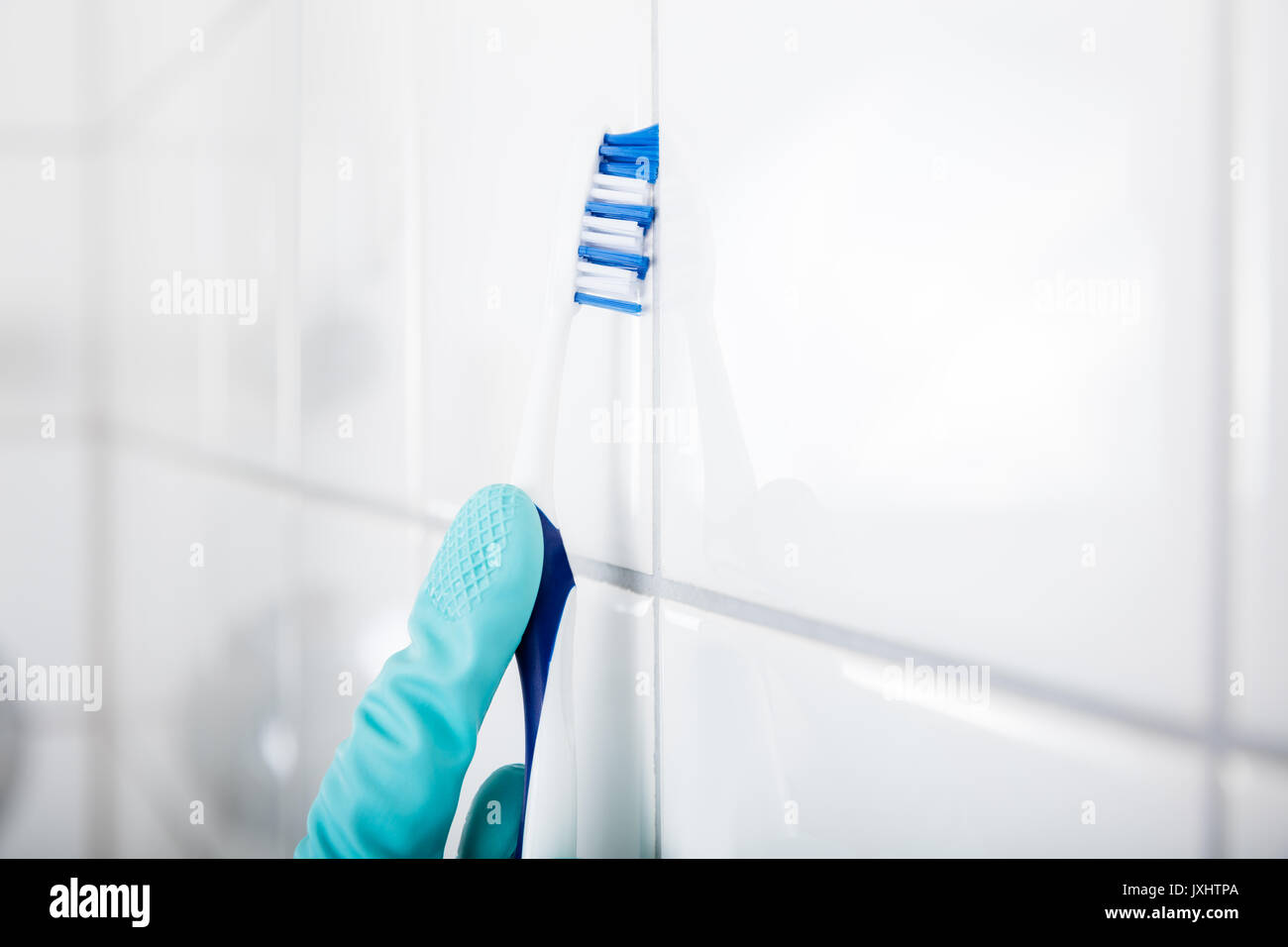Close-up Of Person Hand Cleaning The Dirty White Tile Of The Wall Using ...