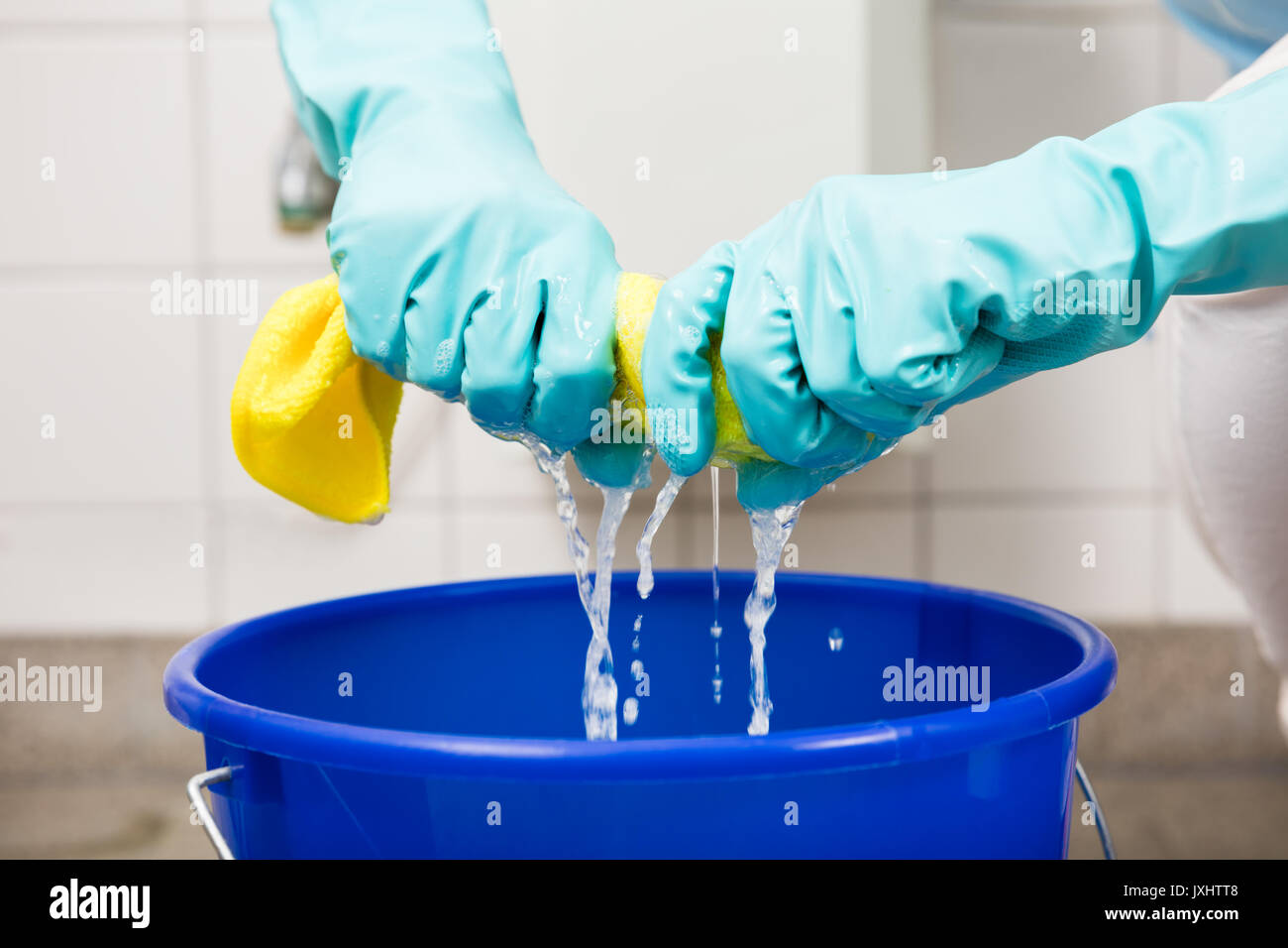 Close-up Of Cleaning Service Woman Hand Squeezing Cloth In Bucket At ...