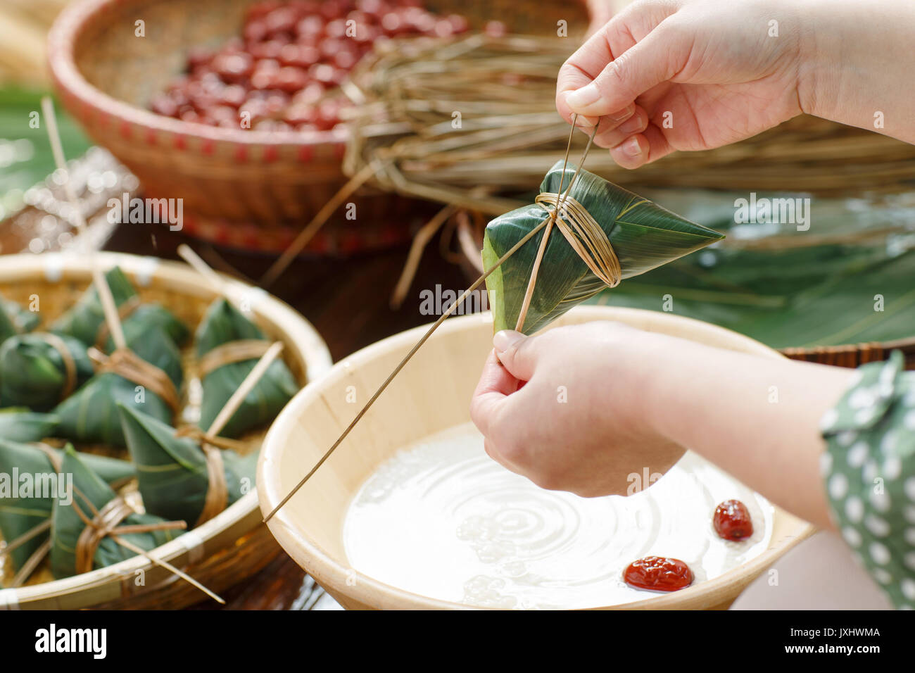 Middle-aged women are making zongzi Stock Photo - Alamy