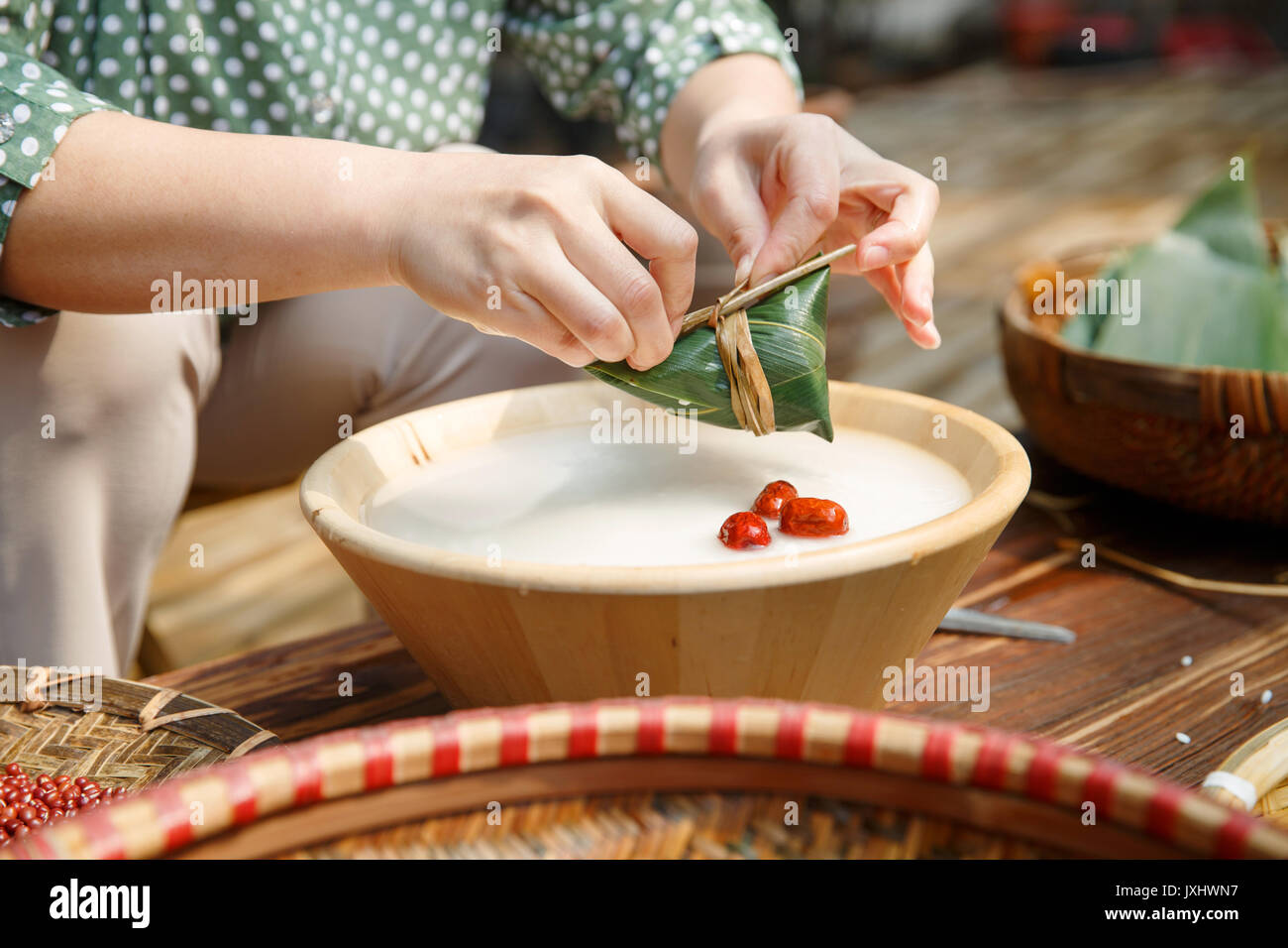 Middle-aged women are making zongzi Stock Photo - Alamy