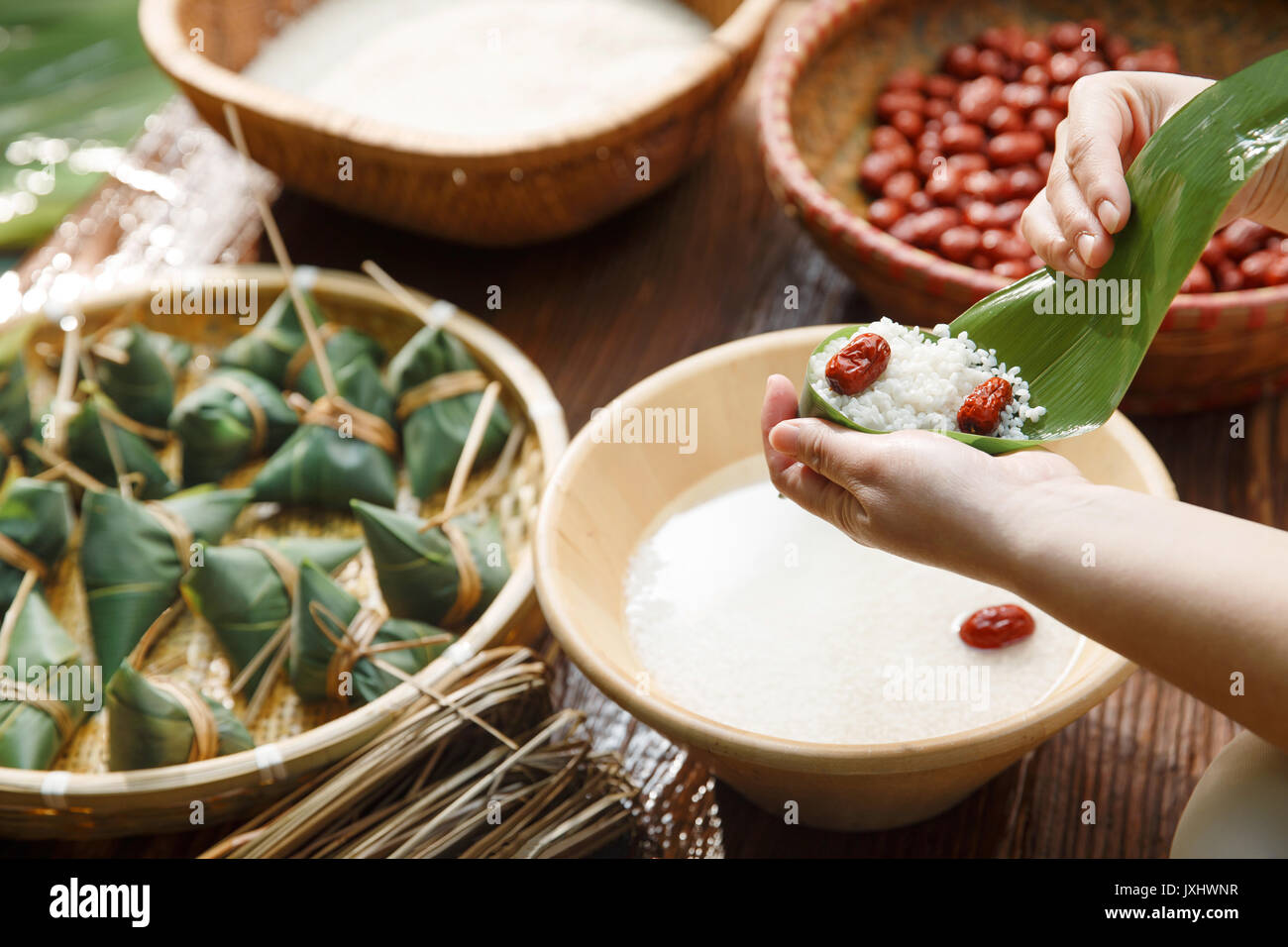 Middle-aged women are making zongzi Stock Photo - Alamy