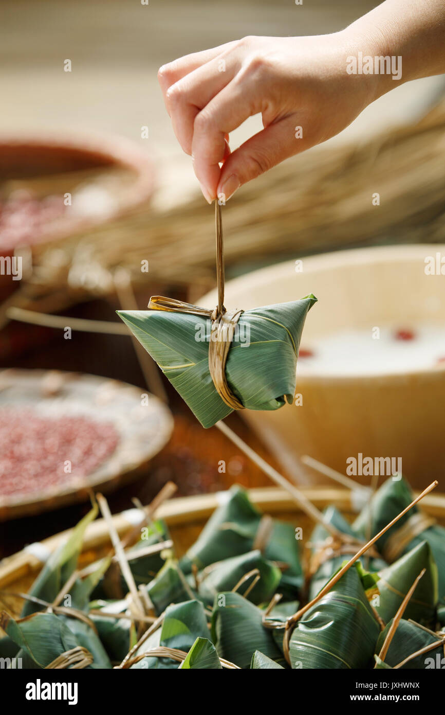 Middle-aged women are making zongzi Stock Photo - Alamy