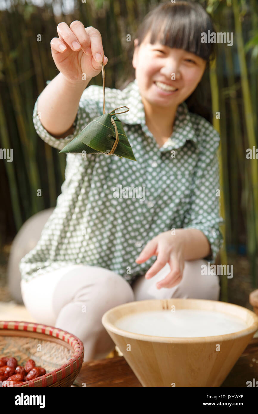 Middle-aged women are making zongzi Stock Photo - Alamy