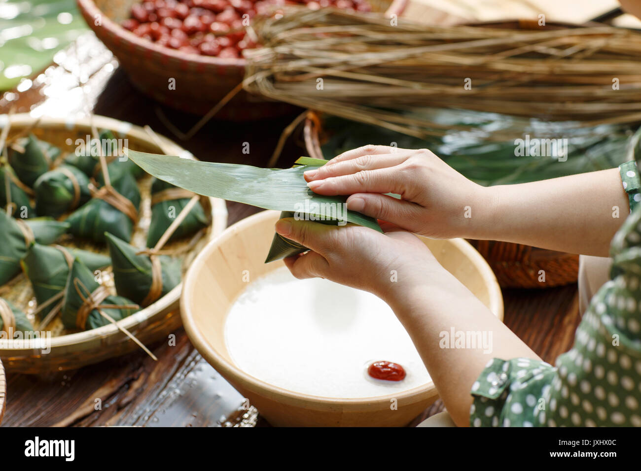 Middle-aged women are making zongzi Stock Photo - Alamy