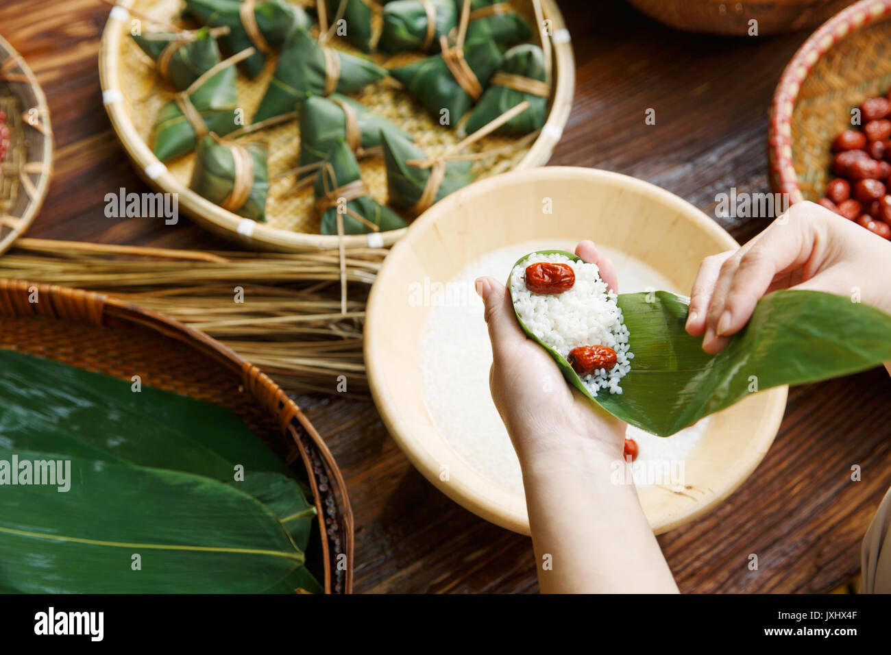 Middle-aged women are making zongzi Stock Photo - Alamy