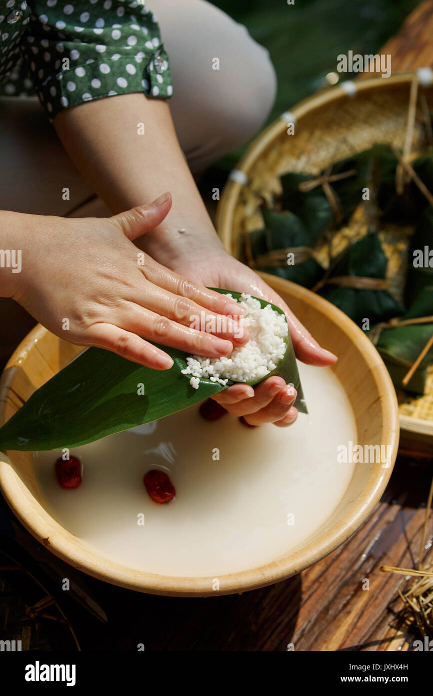 Middle-aged women are making zongzi Stock Photo - Alamy
