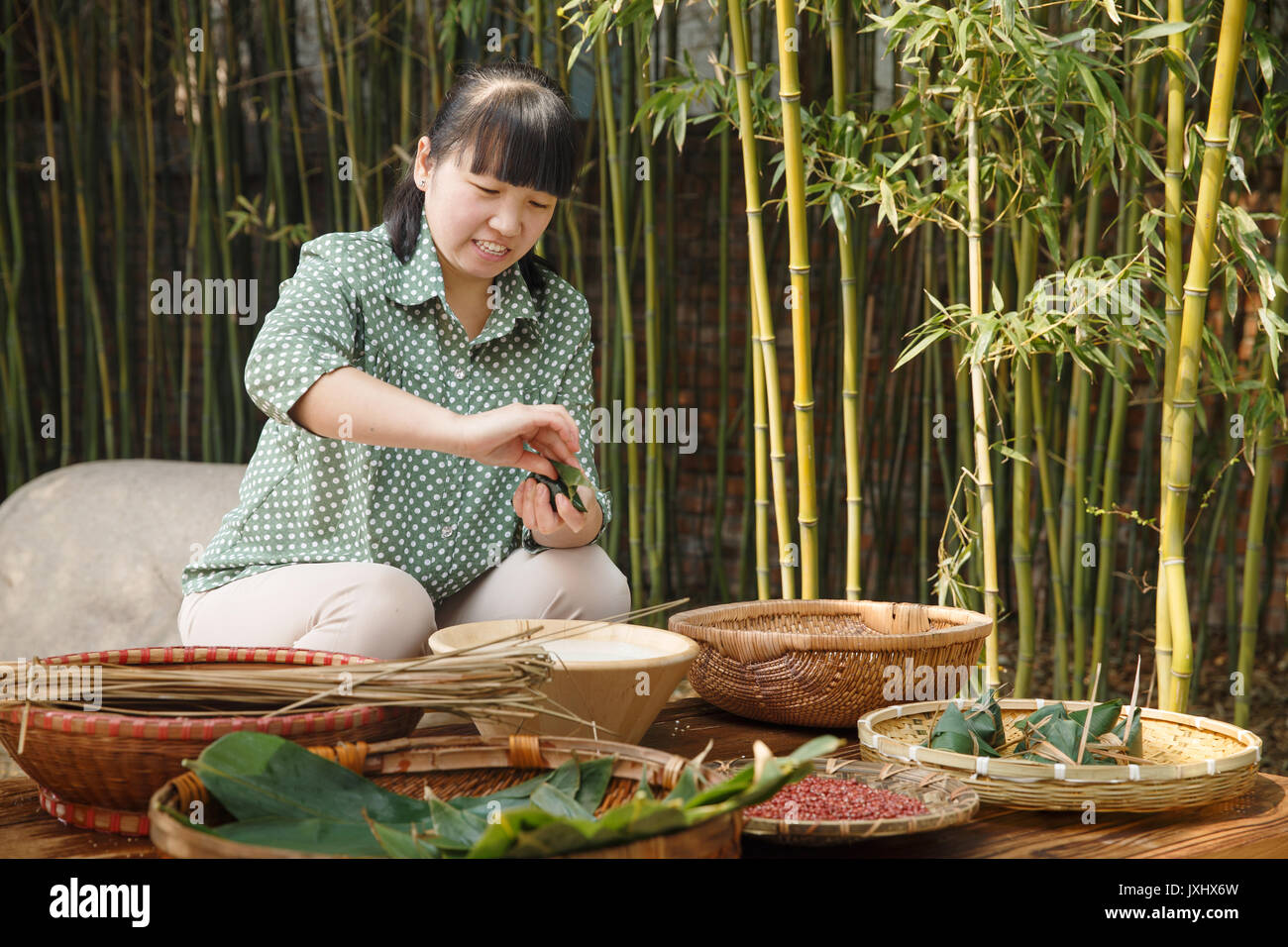 Middle-aged women are making zongzi Stock Photo - Alamy