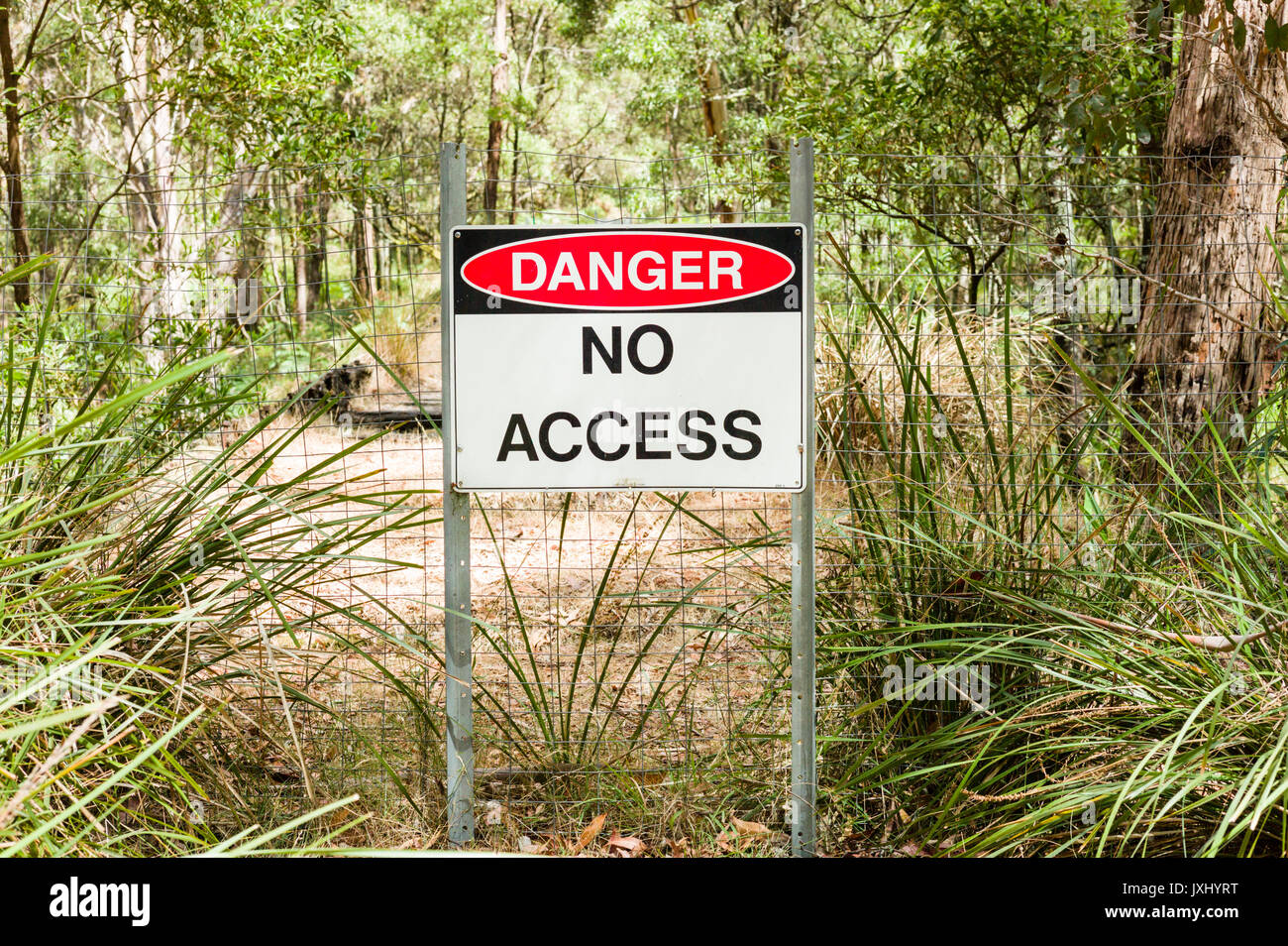 Sign Danger No Access in Australian bushland with wire fence Stock ...
