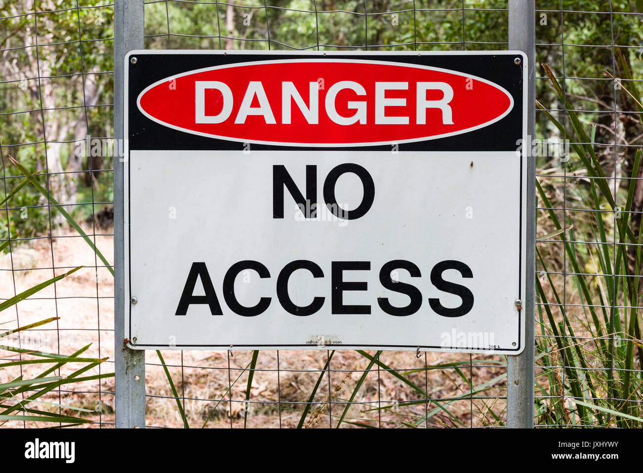 Sign Danger No Access in Australian bushland with wire fence Stock ...