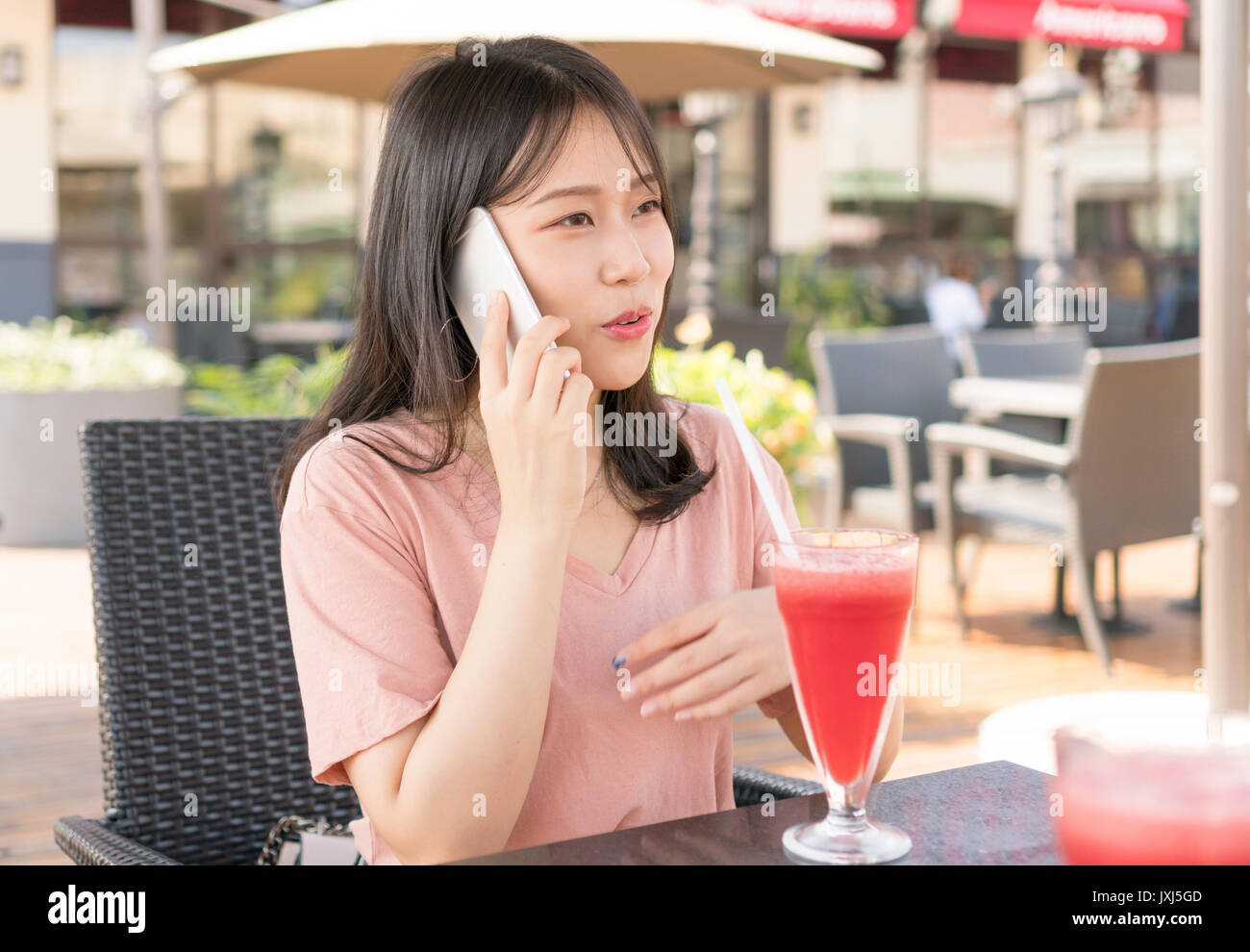 Chinese girl calling in cafe Stock Photo - Alamy