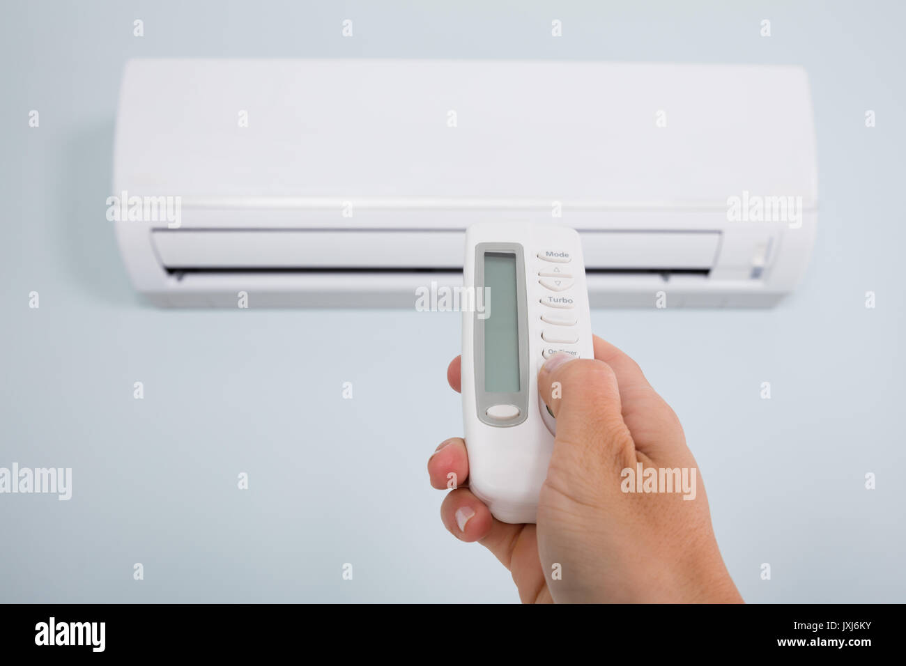Hand remote air conditioner hi-res stock photography and images - Alamy