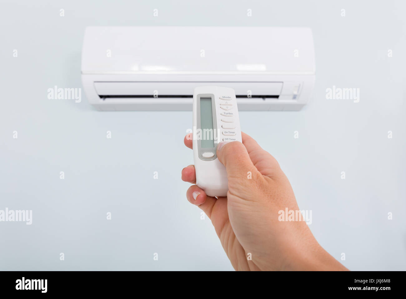 Hand remote air conditioner hi-res stock photography and images - Alamy