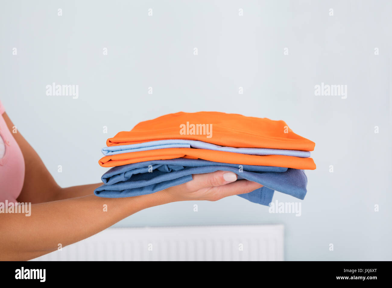 Hand holding clothes hi-res stock photography and images - Alamy