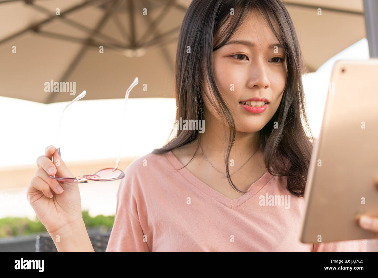 asian girl watching tablet Stock Photo - Alamy