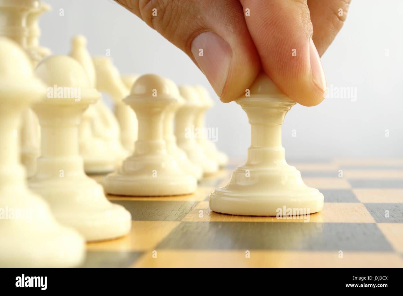 man playing chess, and shows the hand of chess pieces Stock Photo - Alamy