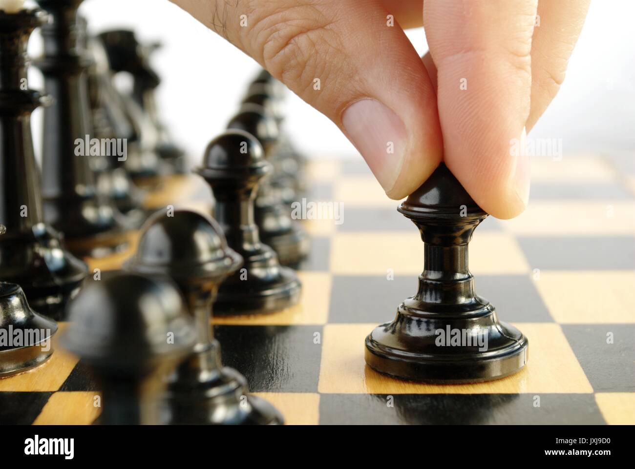 man playing chess, and shows the hand of chess pieces Stock Photo - Alamy