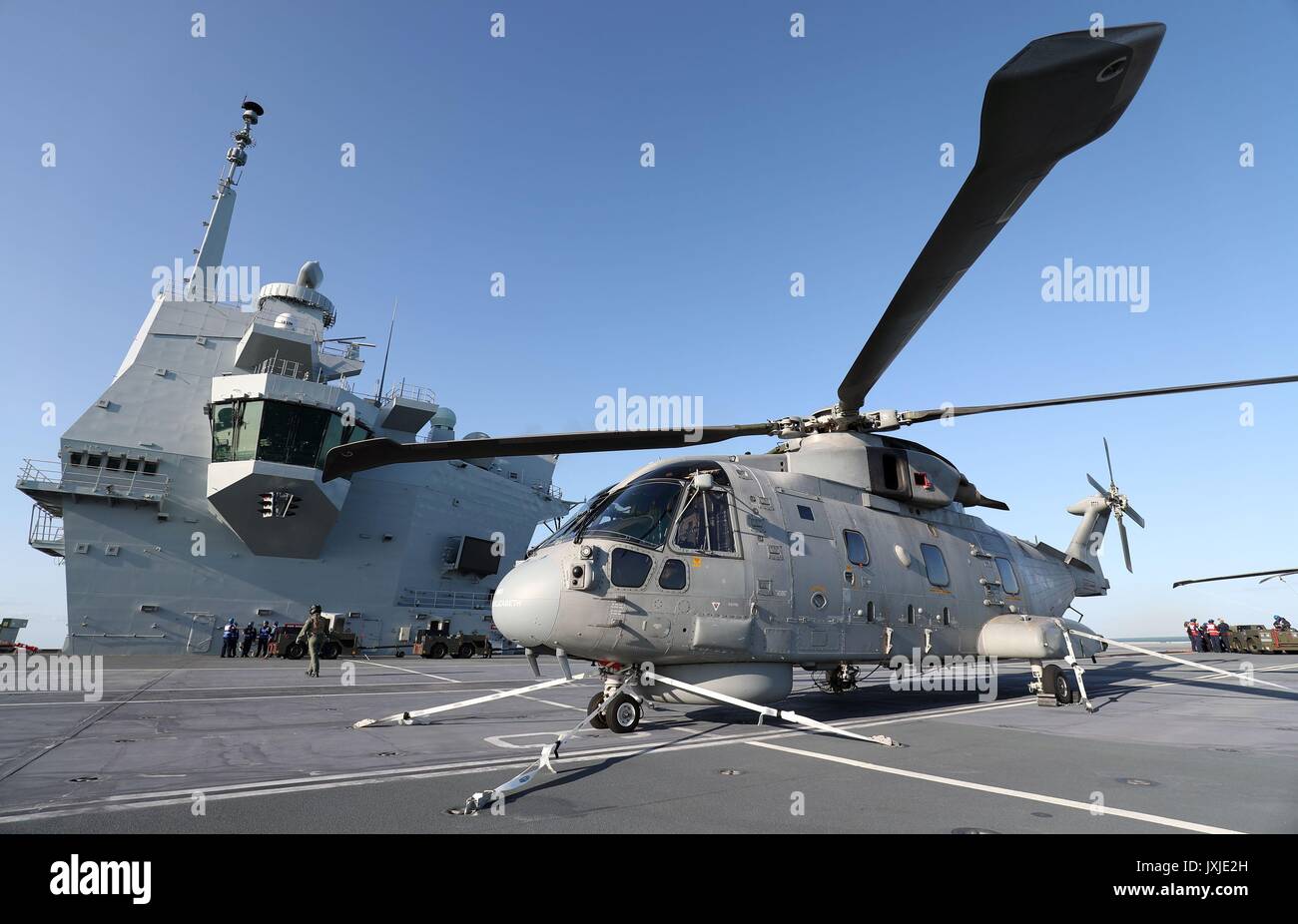 A Merlin helicopter on the flight deck of HMS Queen Elizabeth as she ...