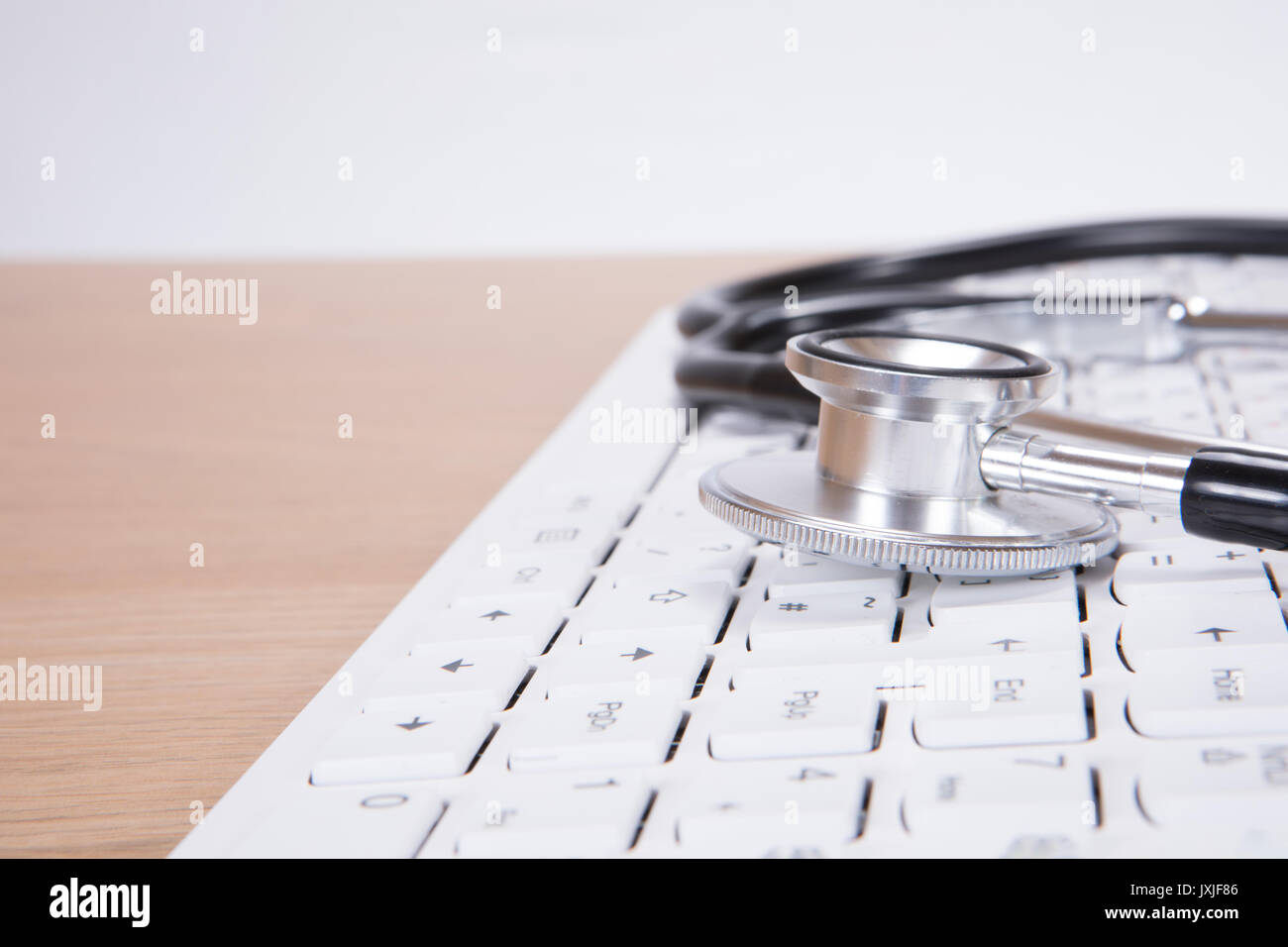 Close-up of stethoscope chestpiece lying on computer keyboard Stock ...