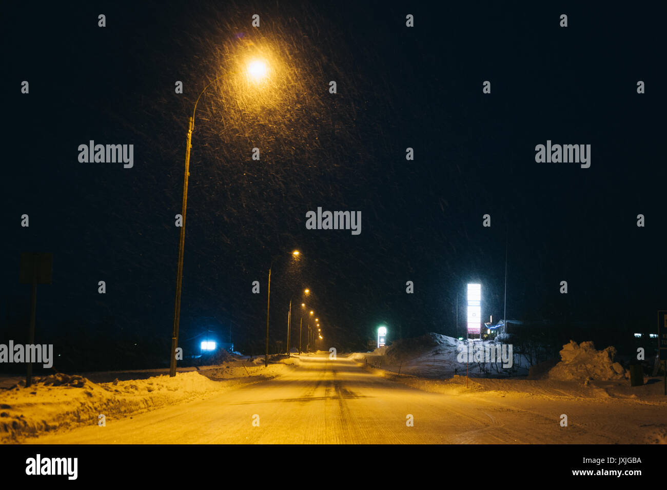 Road in village with streetlights and snow Stock Photo - Alamy