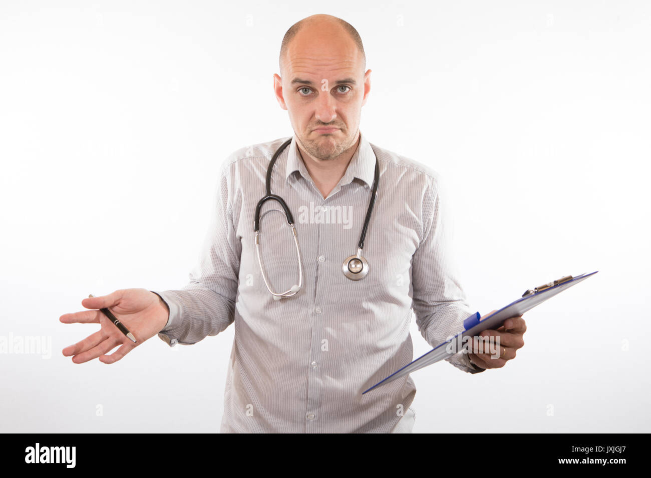 Doctor shrugging his shoulders and grimacing as he holds a clipboard to ...
