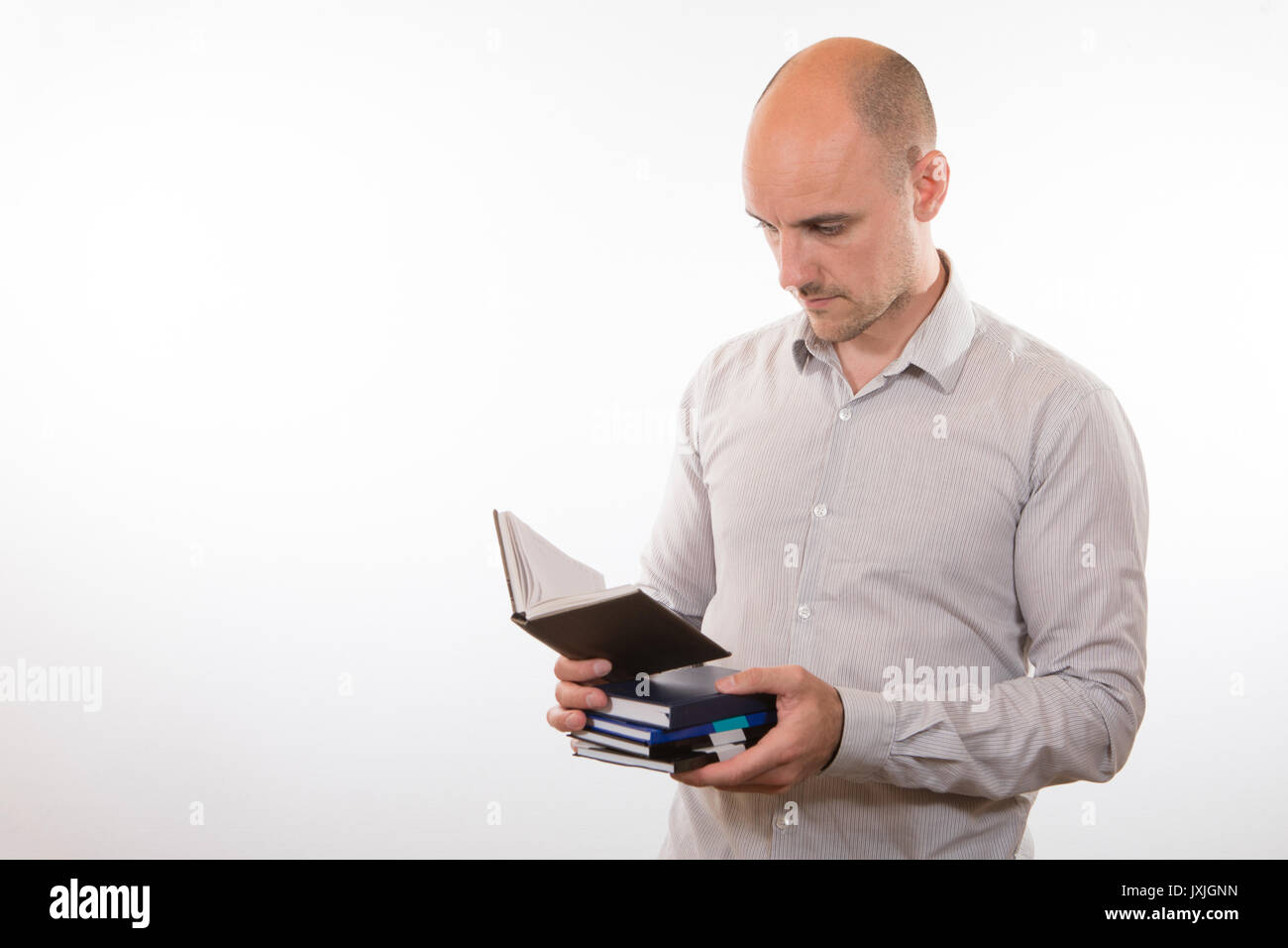 Standing man on book pile hi-res stock photography and images - Alamy